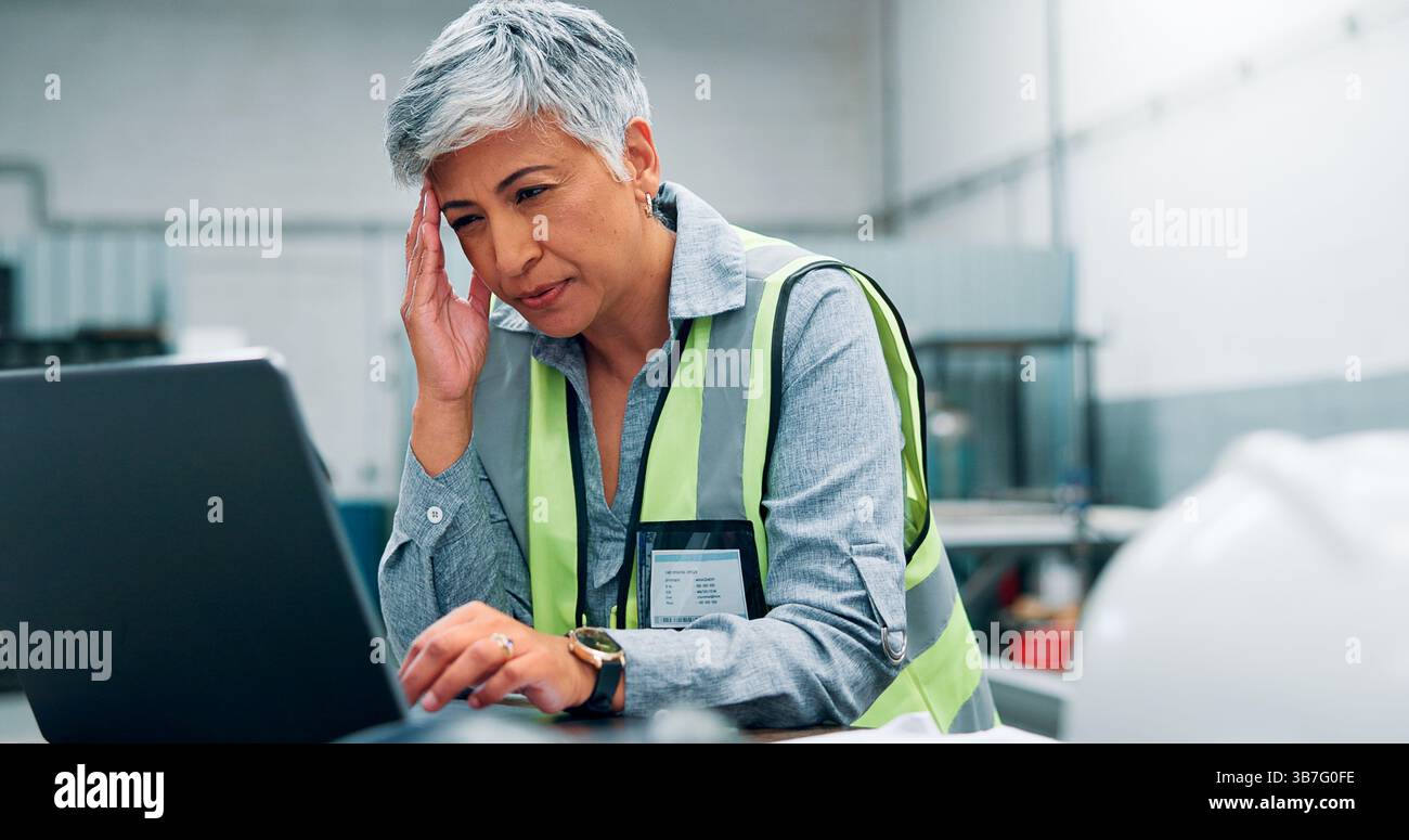 Engineer, laptop and stress with woman in workshop for manufacturing ...