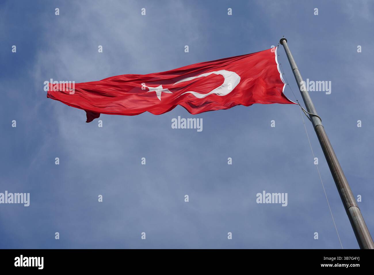 Turkish flag has a white crescent moon and a star on a red background ...