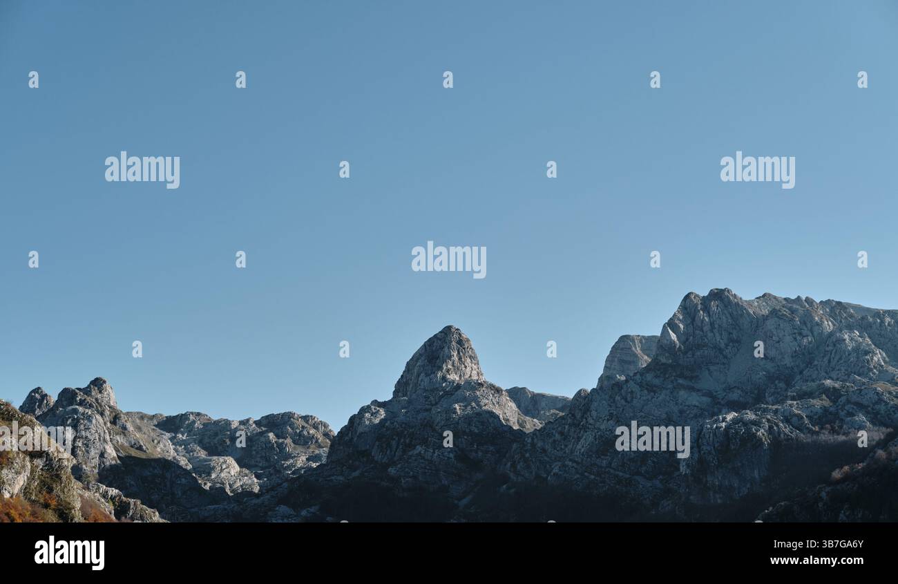 Majestic rocky peaks of the Montenegrin mountains rise under a clear ...