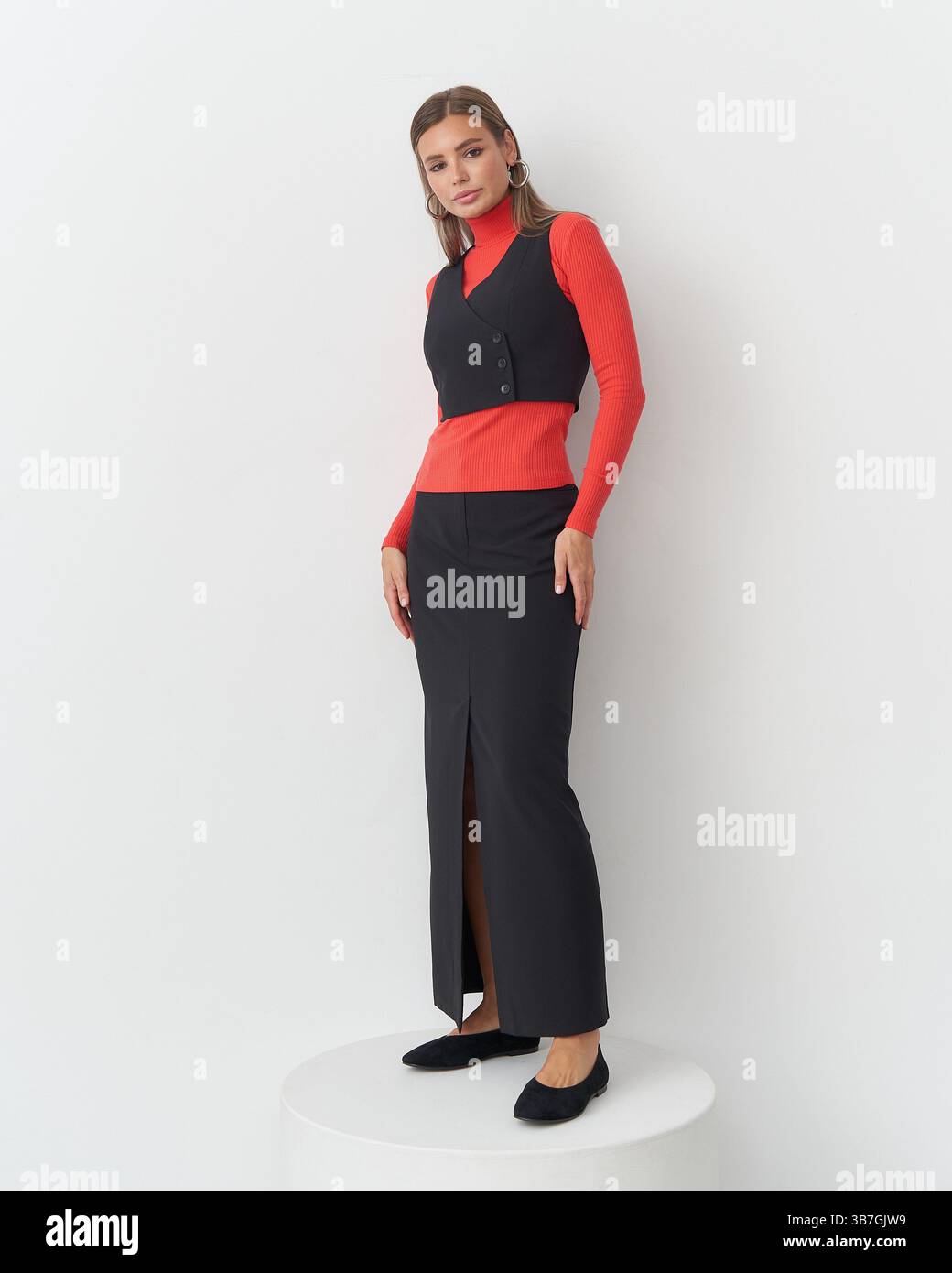 Fashion-forward female model exudes confidence in contemporary studio ...