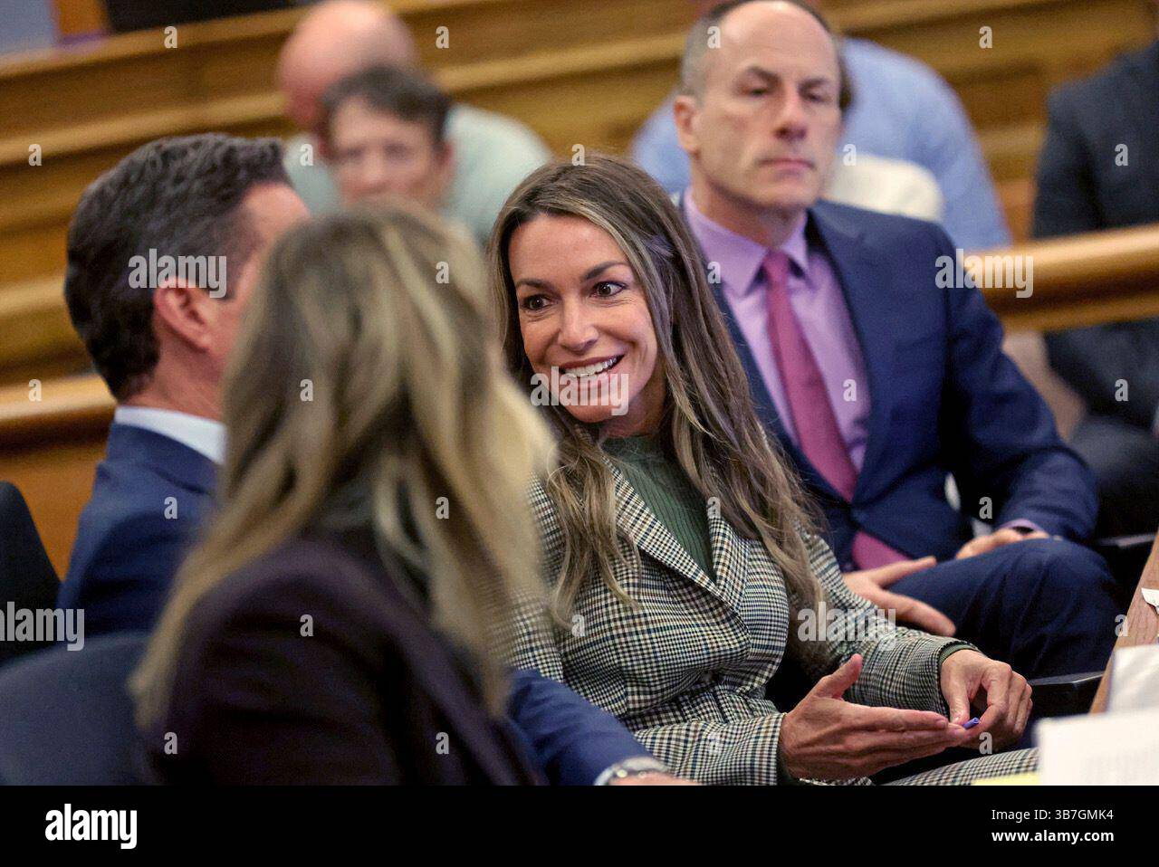 Karen Read smiles as she talks with her attorneys during her trial at ...