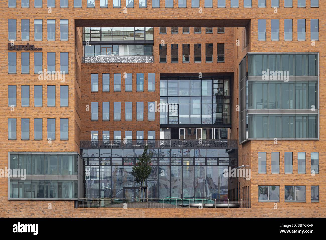 A modern brick building with many windows and a large frame in the ...