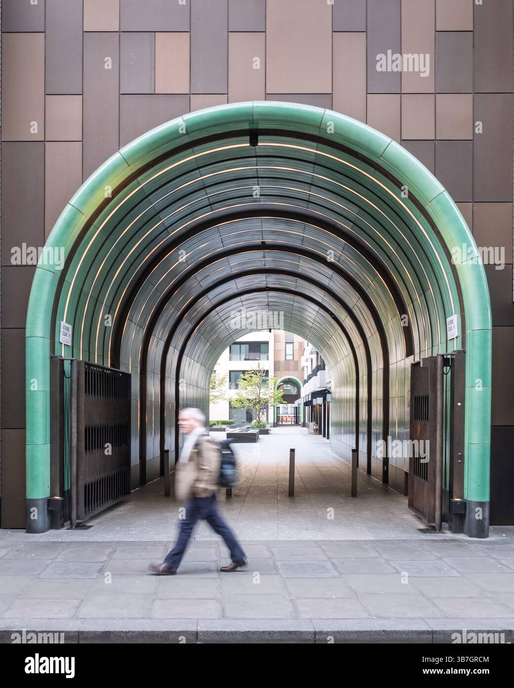 London, England - 28th April 2025: A man walks past the arched entrance ...