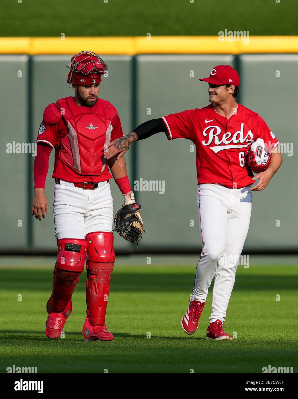 Cincinnati Reds pitcher Chase Petty, right, walks to the dugout with ...