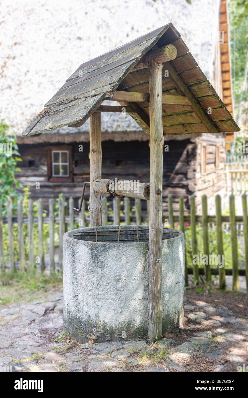 Old well with a winch in the village Stock Photo - Alamy