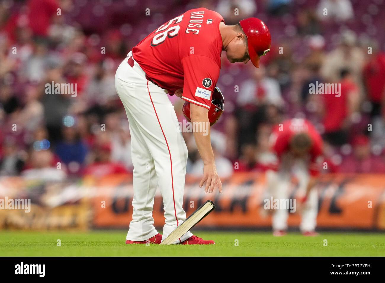 Cincinnati Reds third base coach J.R. House (56) looks to pick up a ...