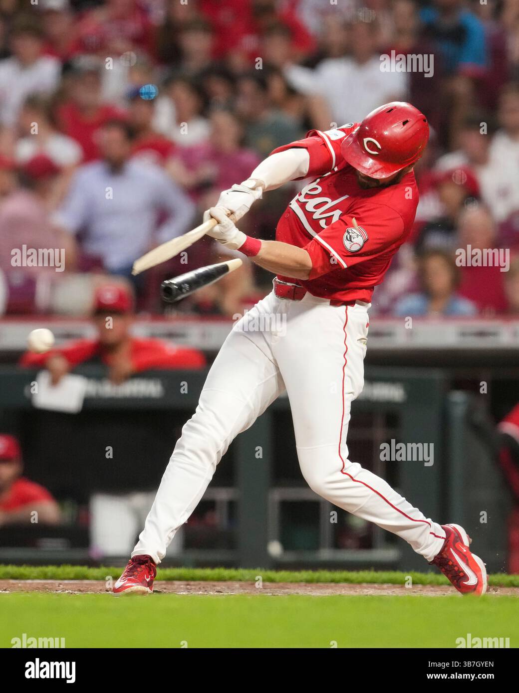 Cincinnati Reds' Gavin Lux holds onto his broken bat after grounding ...