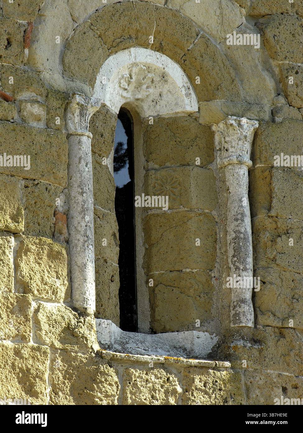 Historic stone carving, narrow window on the Romanesque cathedral of St ...