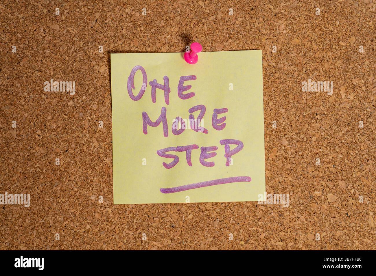 Yellow sticky note with encouraging message pinned on cork board Stock ...