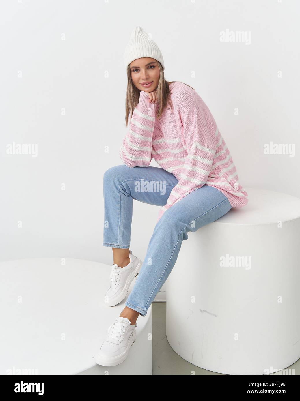 Stylish female model poses gracefully in a chic studio setting ...