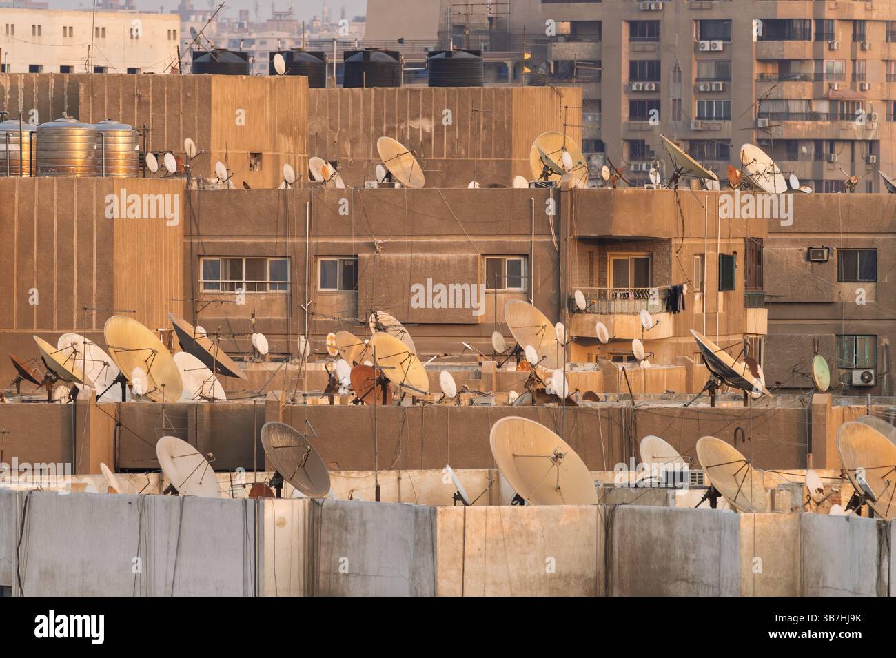 Many satellite dishes crowd the rooftops of apartment buildings in Cairo near the airport Stock ...