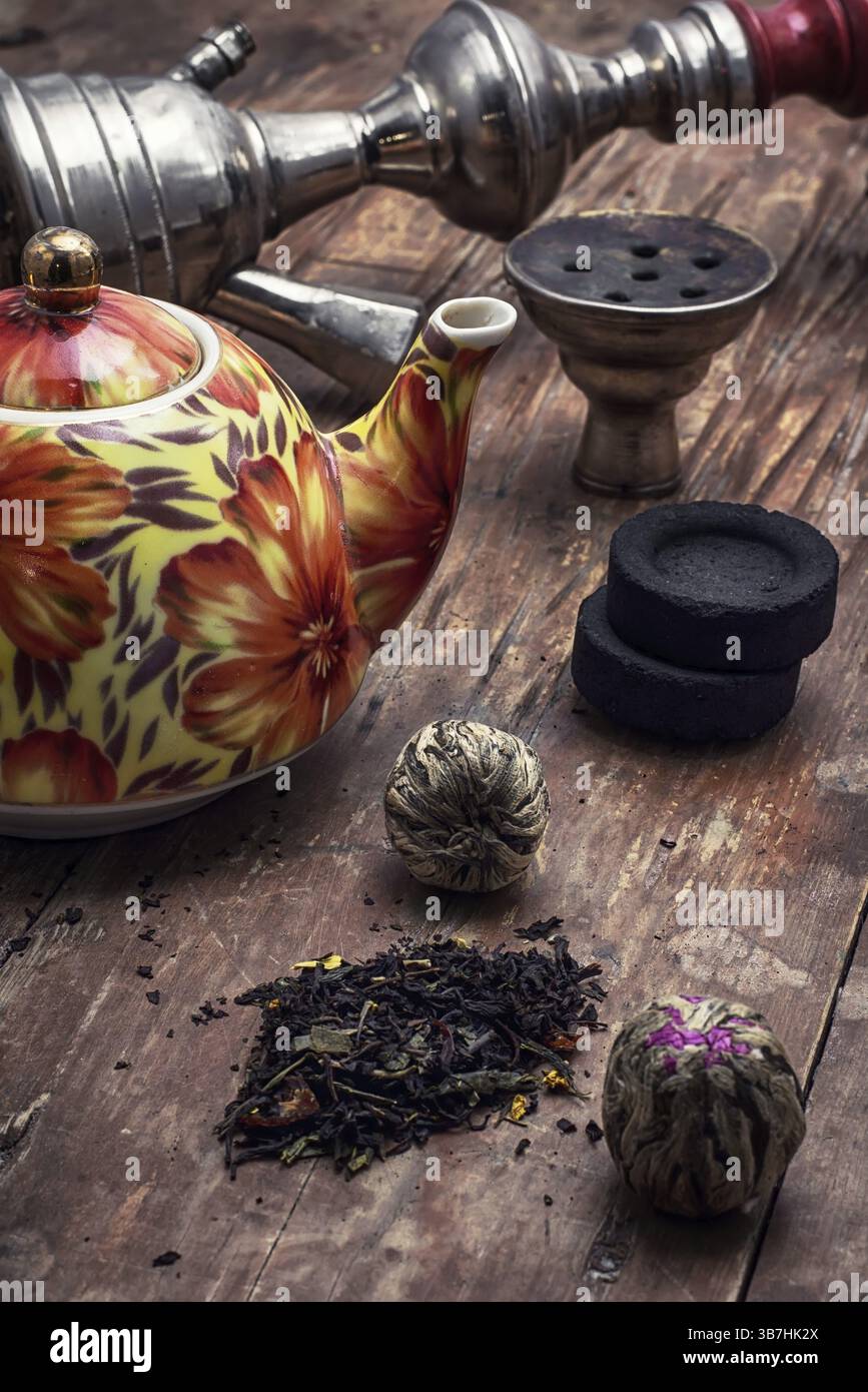 Accessories to Smoking hookah and dry tea leaves.image is tinted in ...