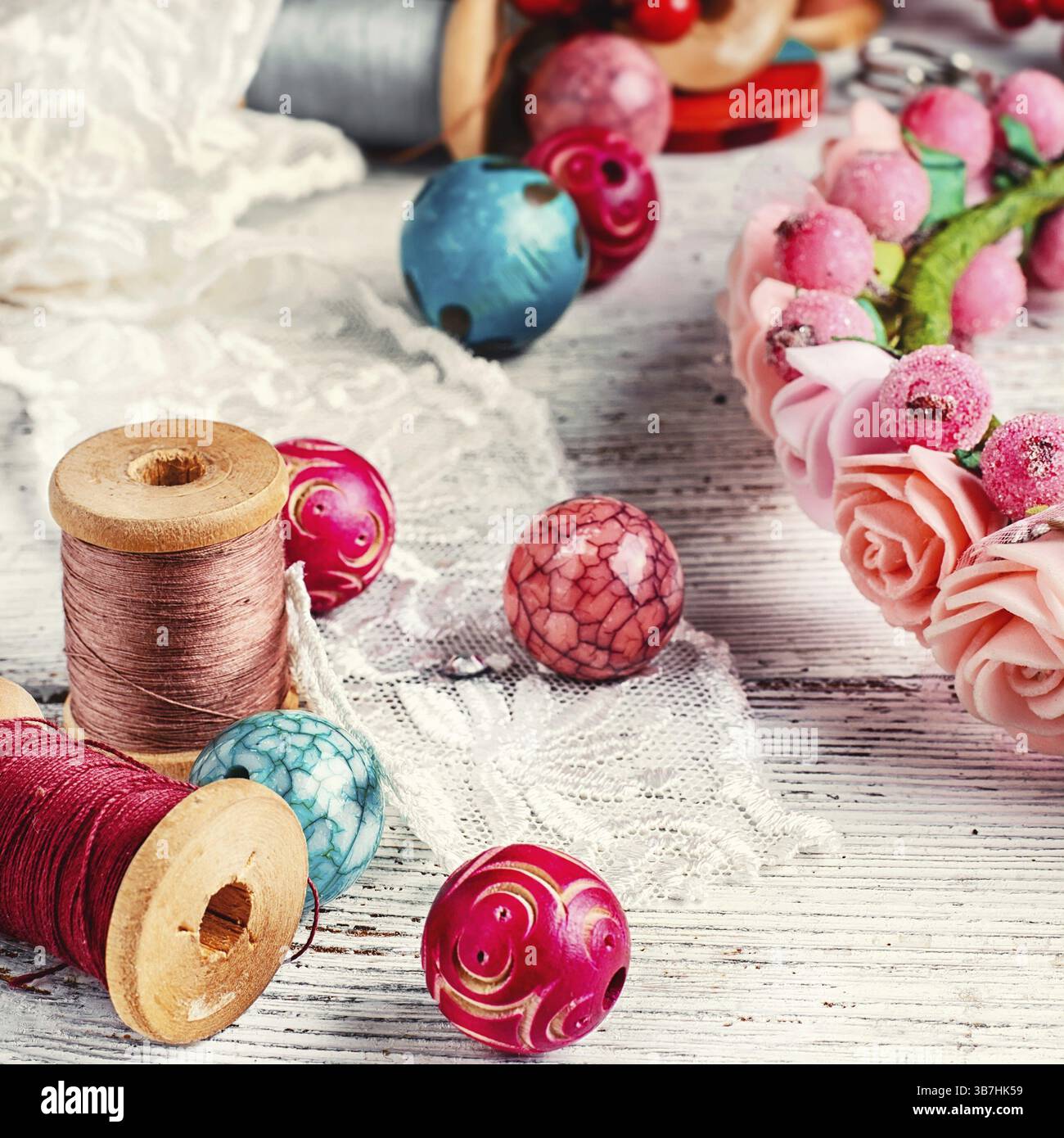 White lace, sewing thread and charming wooden bead Stock Photo - Alamy