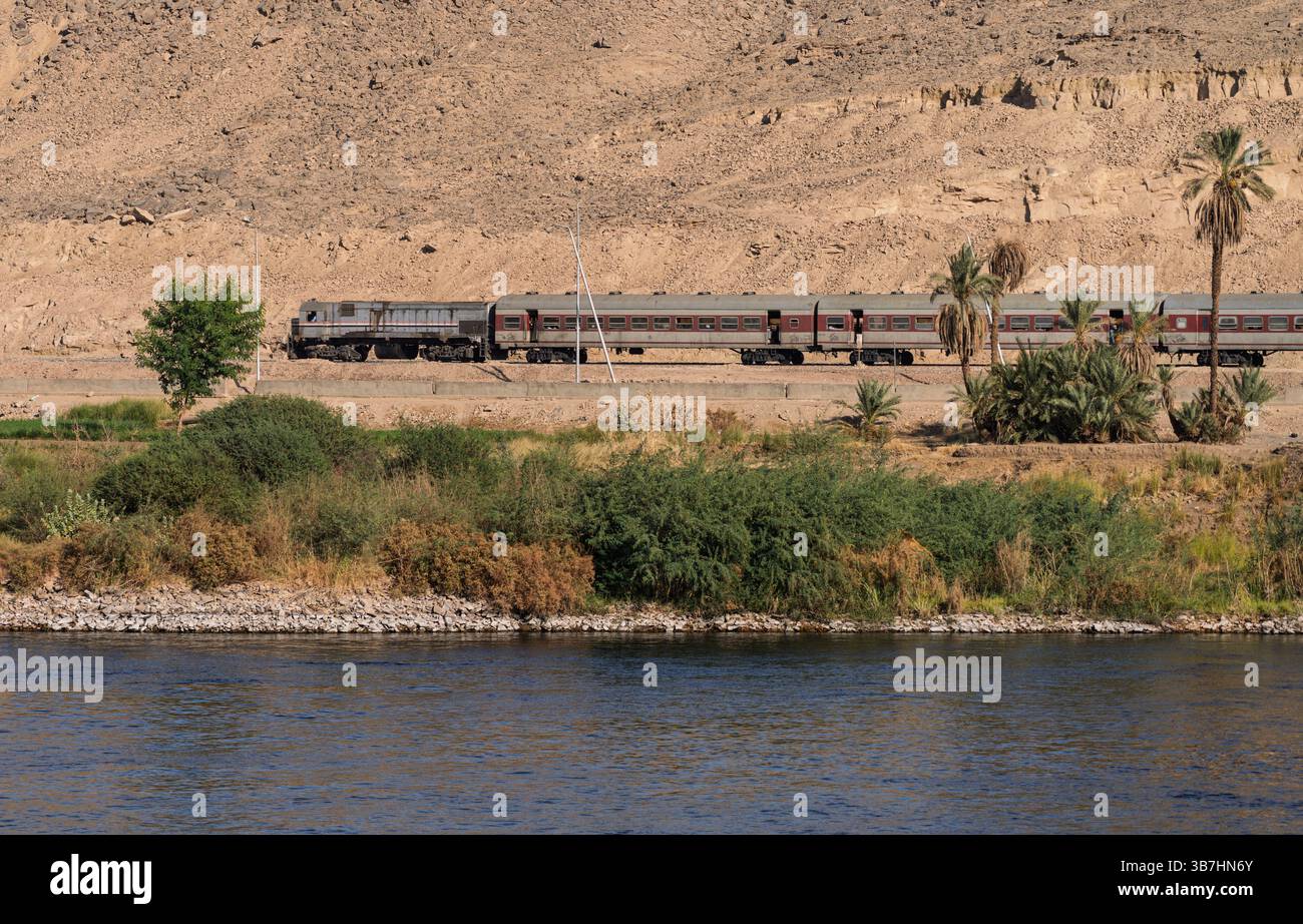 Egyptian passenger train alongside the River Nile near Aswan and ...