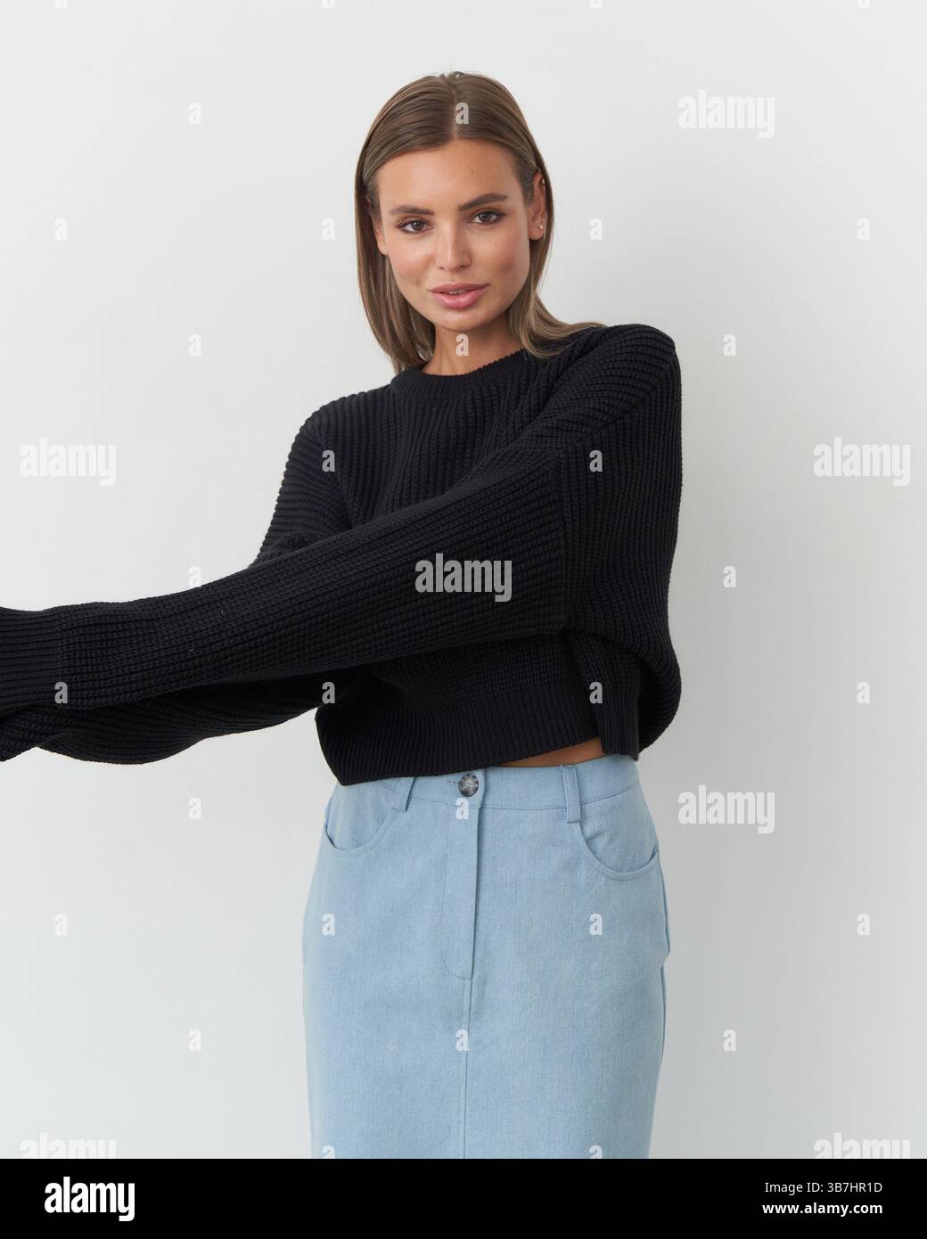 Fashion forward female model showcases stylish outfit in a bright ...