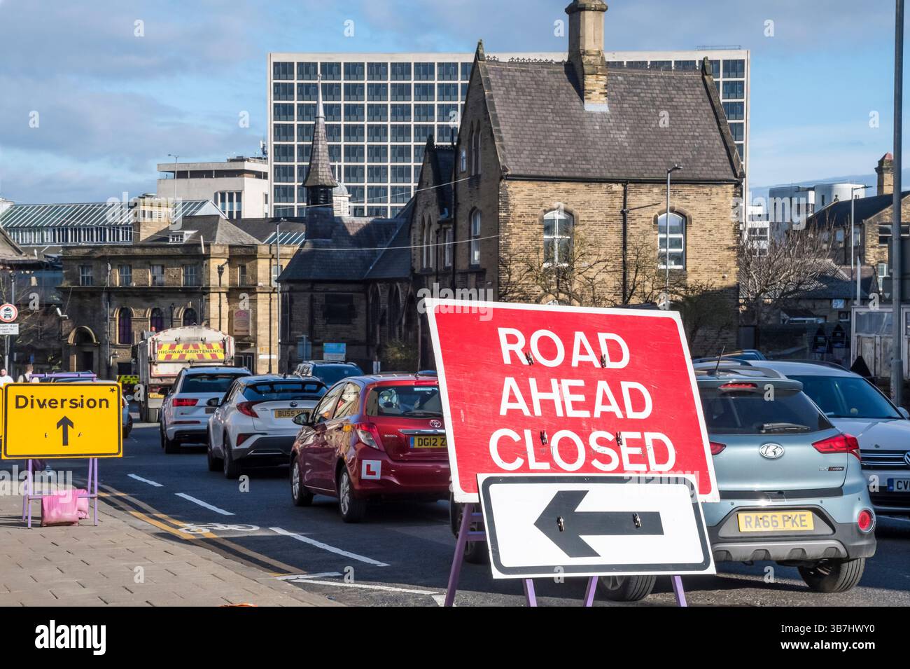 Road Ahead Closed and Diversion road signs with queueing traffic in ...
