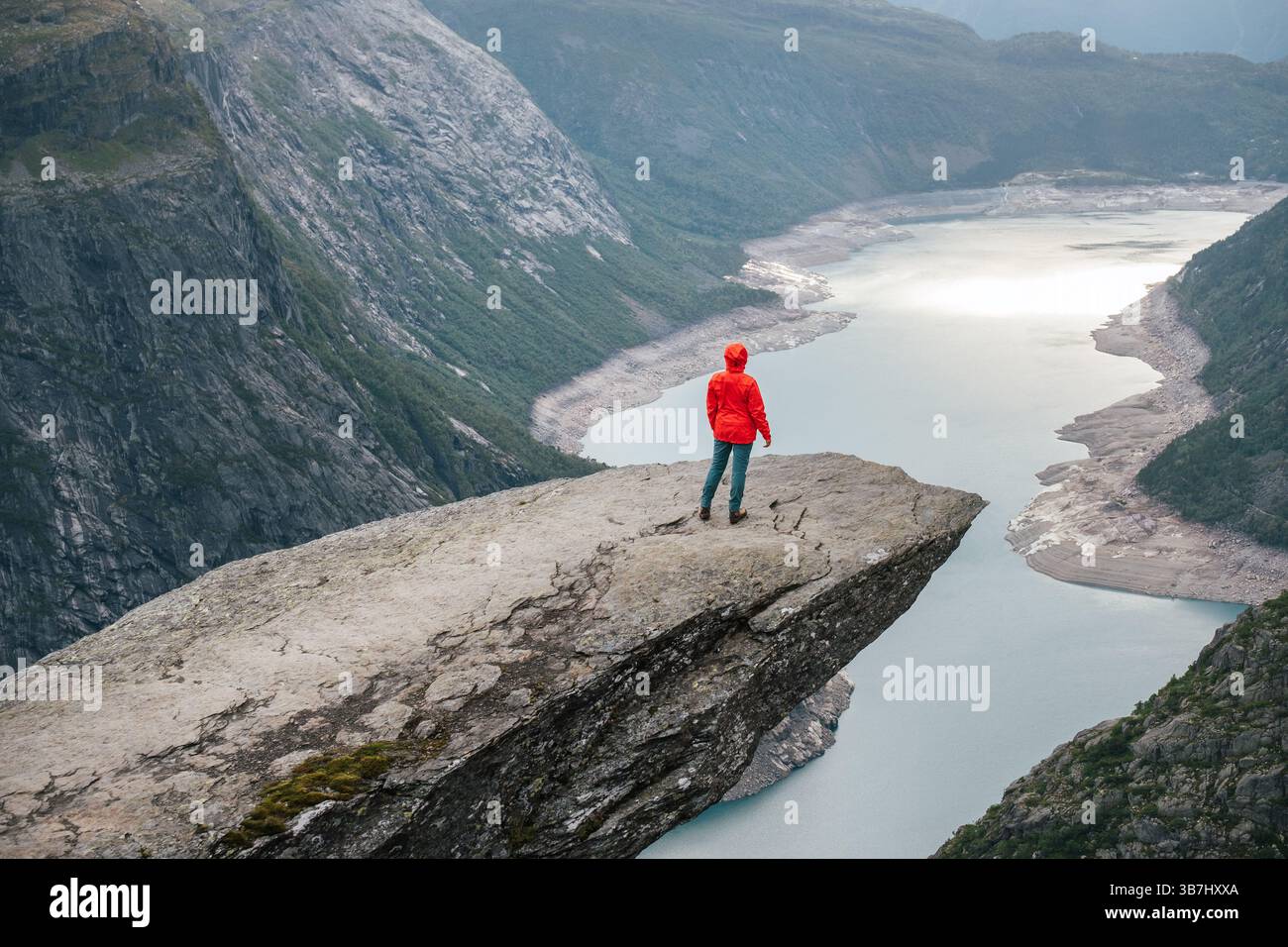 Woman trekker dressed bright red jacket enjoying glacier ...