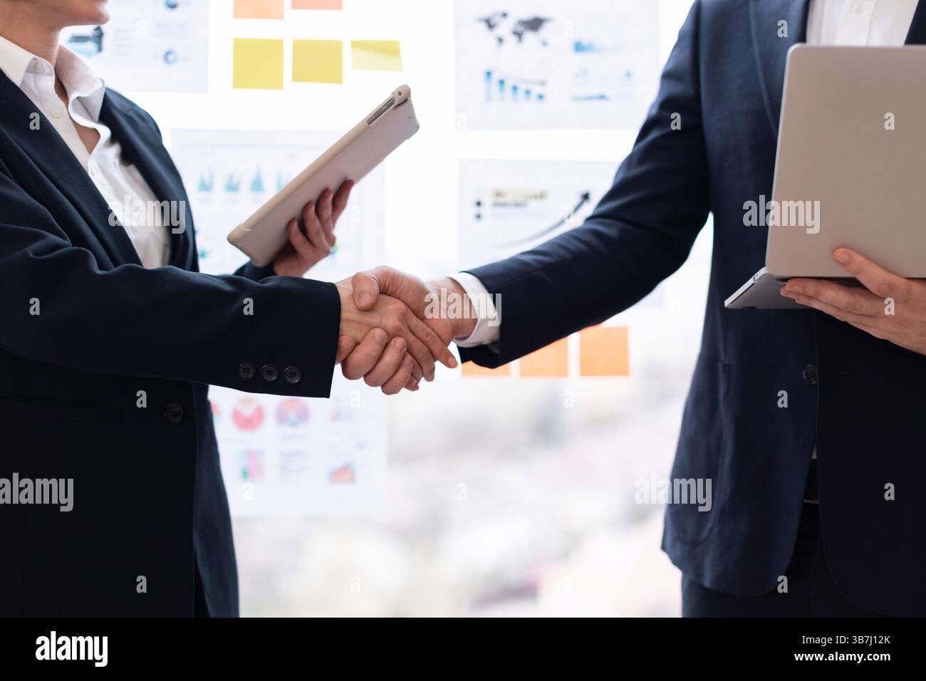 Professional business handshake between executives in formal office ...