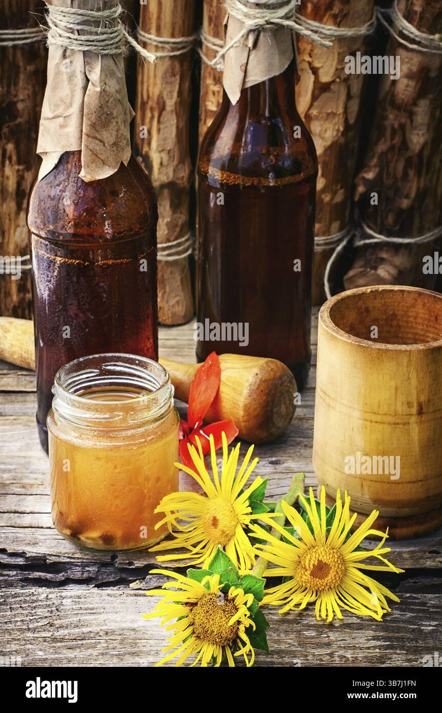 Medicinal folk remedy tincture from the roots of inula Stock Photo - Alamy