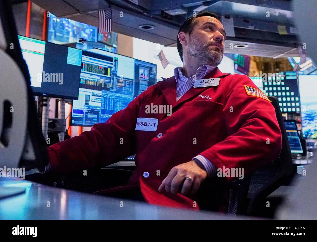 Trader Robert Greason works on the floor of the New York Stock Exchange ...
