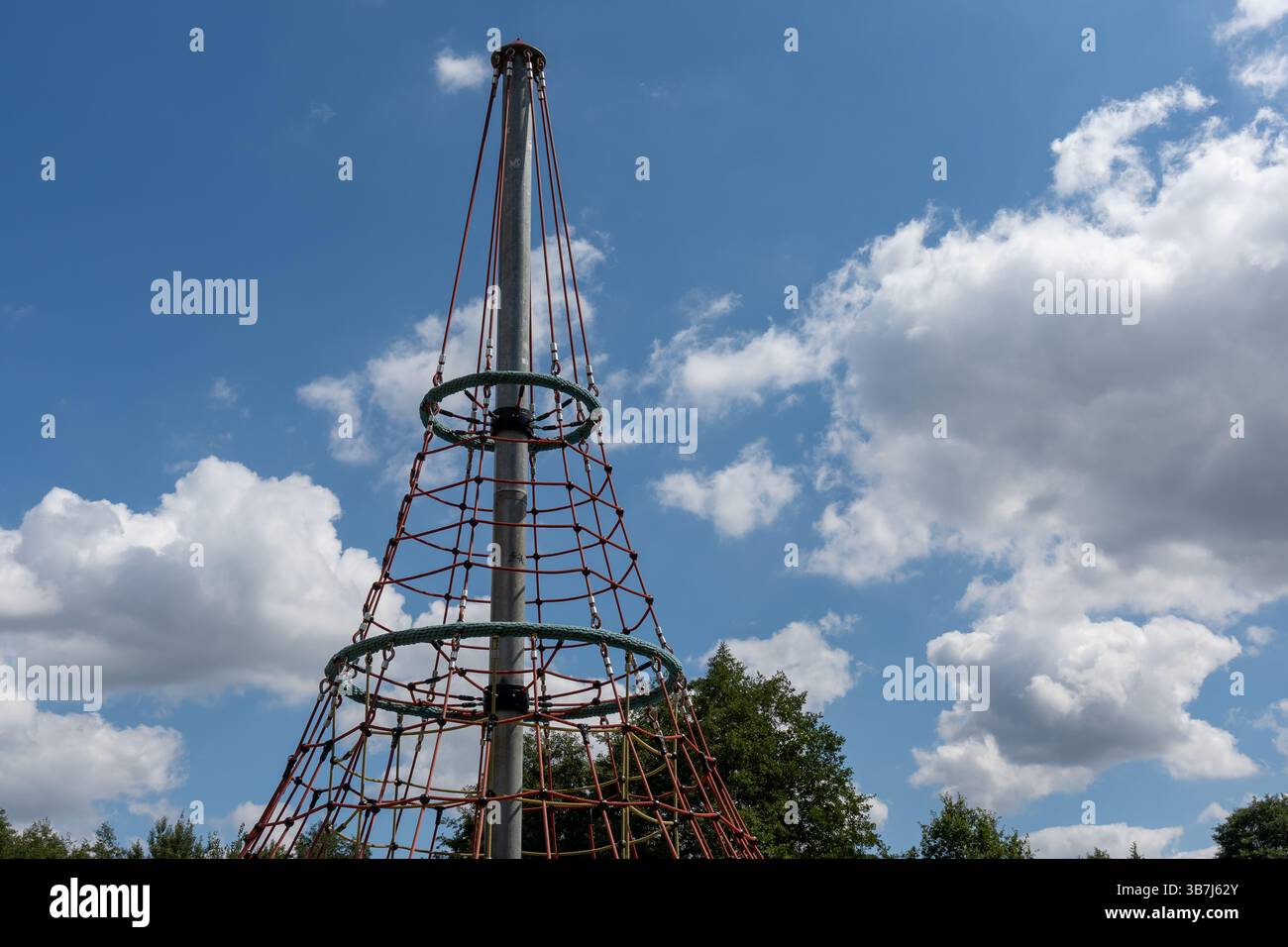 High rope climbing structure for children on playground under blue sky ...