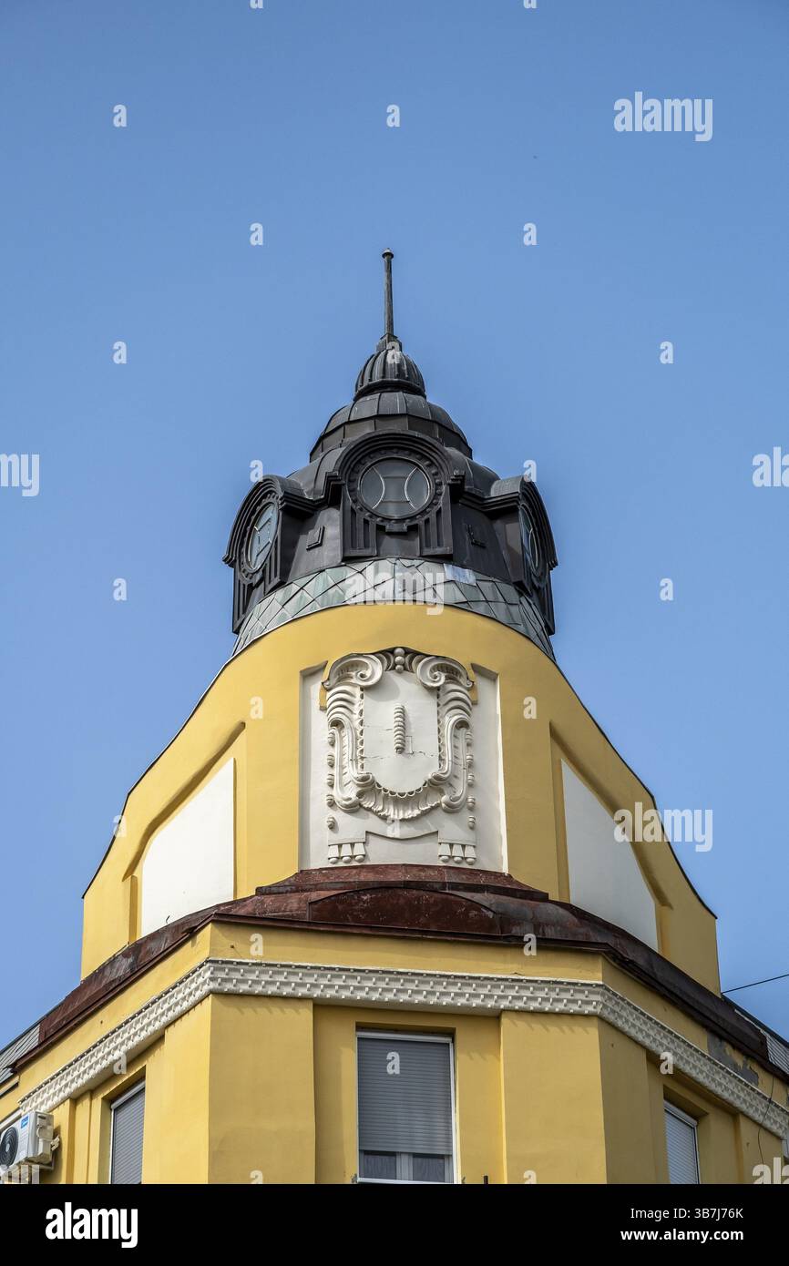 Yellow corner house with tower and stucco facade Stock Photo - Alamy