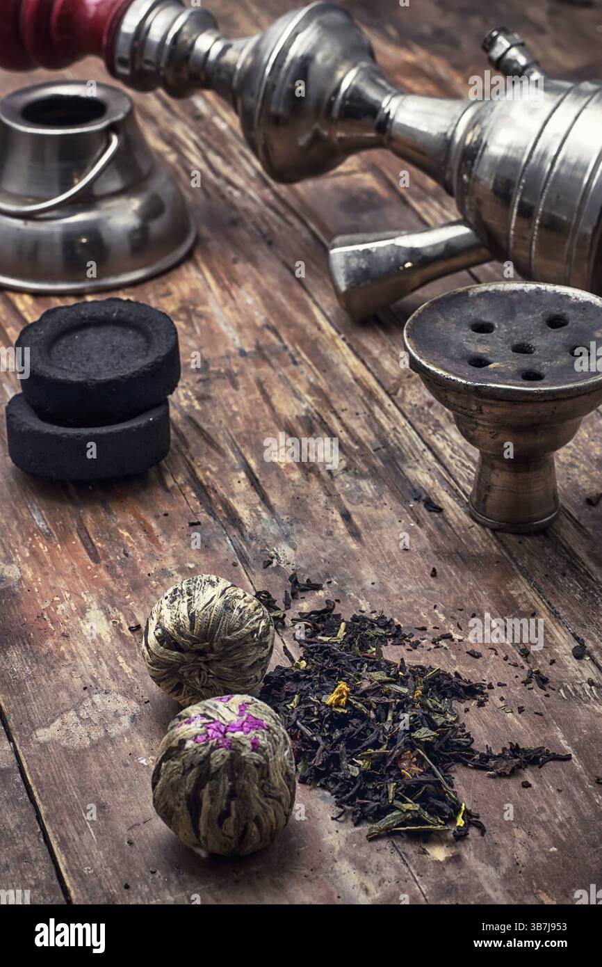 Accessories to Smoking hookah and dry tea leaves.image is tinted in ...