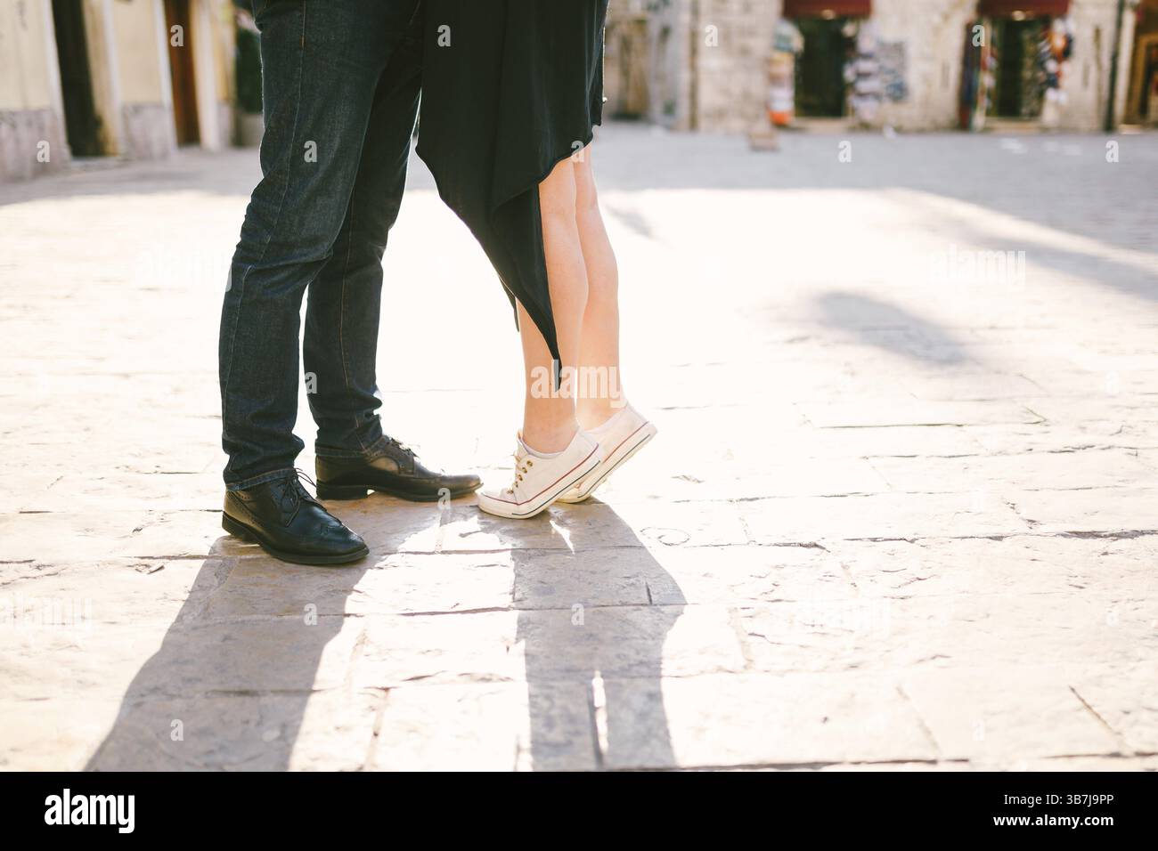 Closeup of couple's feet facing each other on a paved road Stock Photo ...