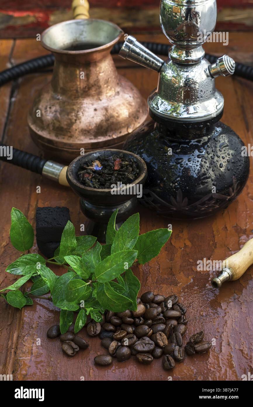 Hookah with fruit flavour on wooden table in vintage style Stock Photo ...