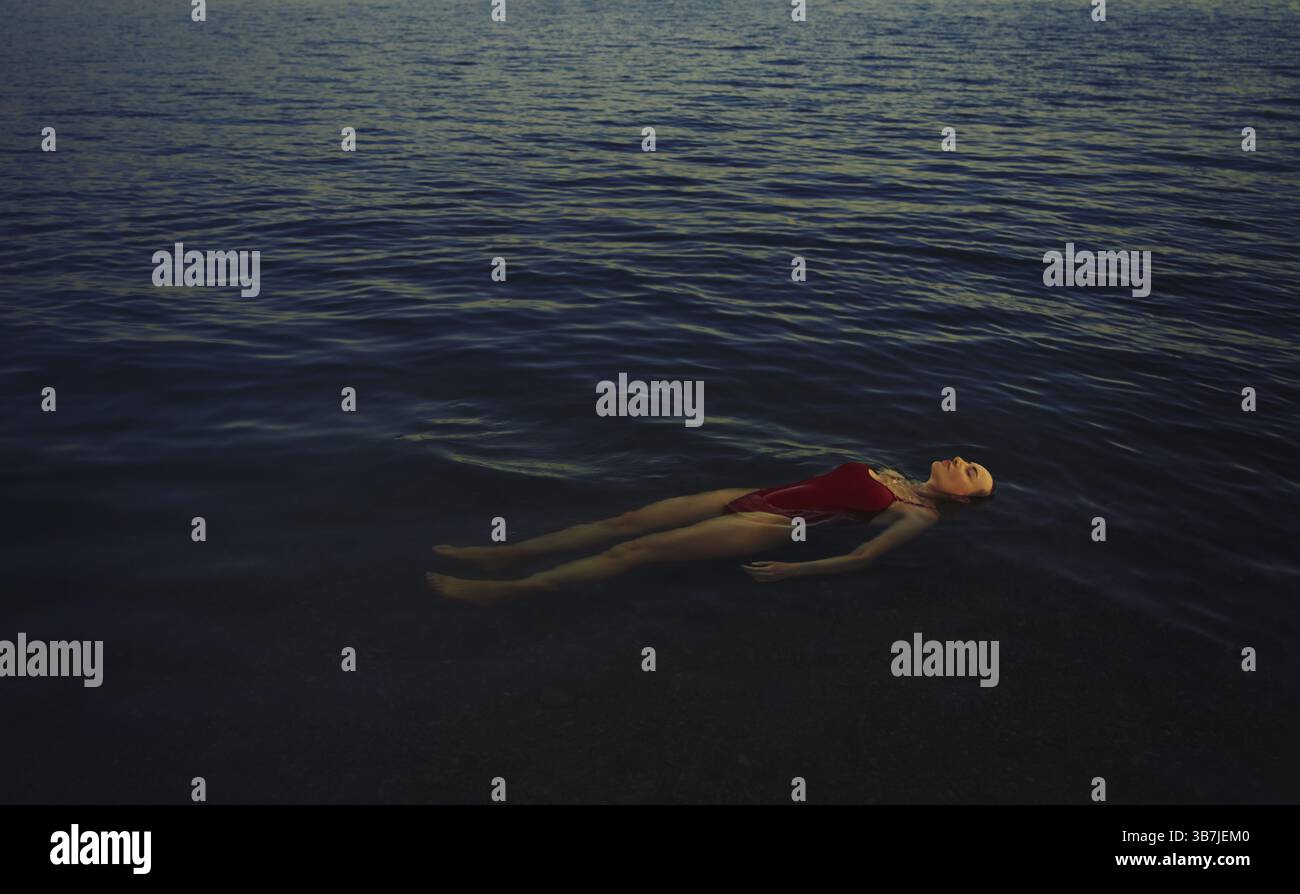 Serene blond woman lying down and relaxing in the rippled sea Stock ...