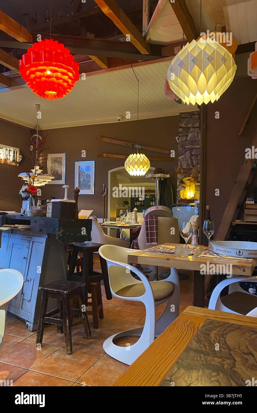 Cozy interior of a traditional Swiss restaurant with warm lighting ...