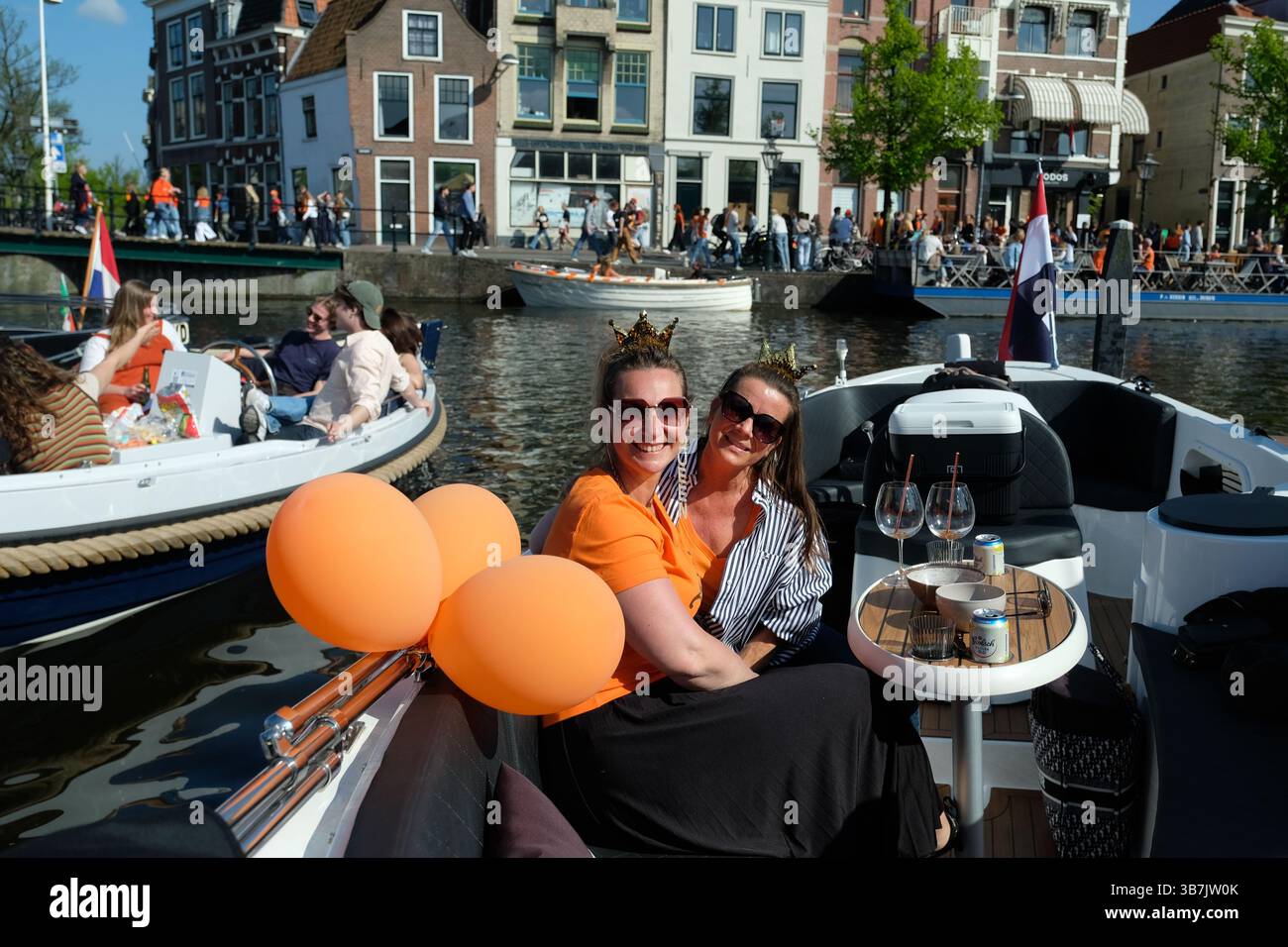 Dutch women poses inside a boat docked at a canal during the King's Day ...