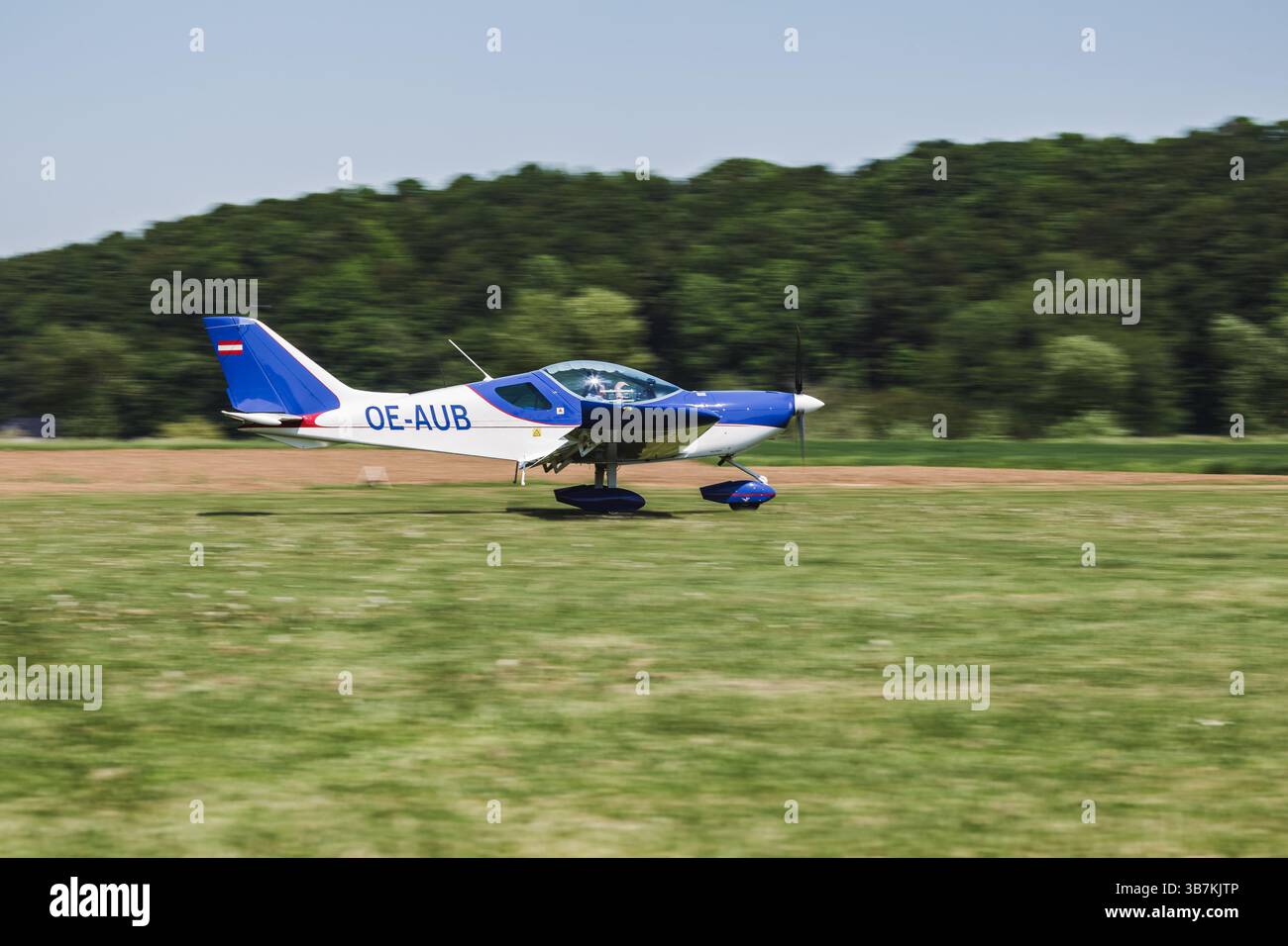 An airplane on a grass runway. The aircraft is ready to fly. It's a ...