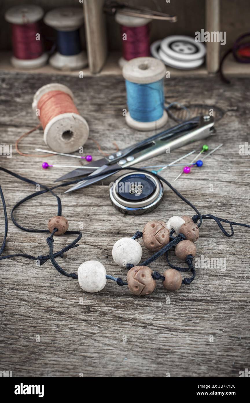 Set of threads and buttons on wooden background.selective focus Stock ...