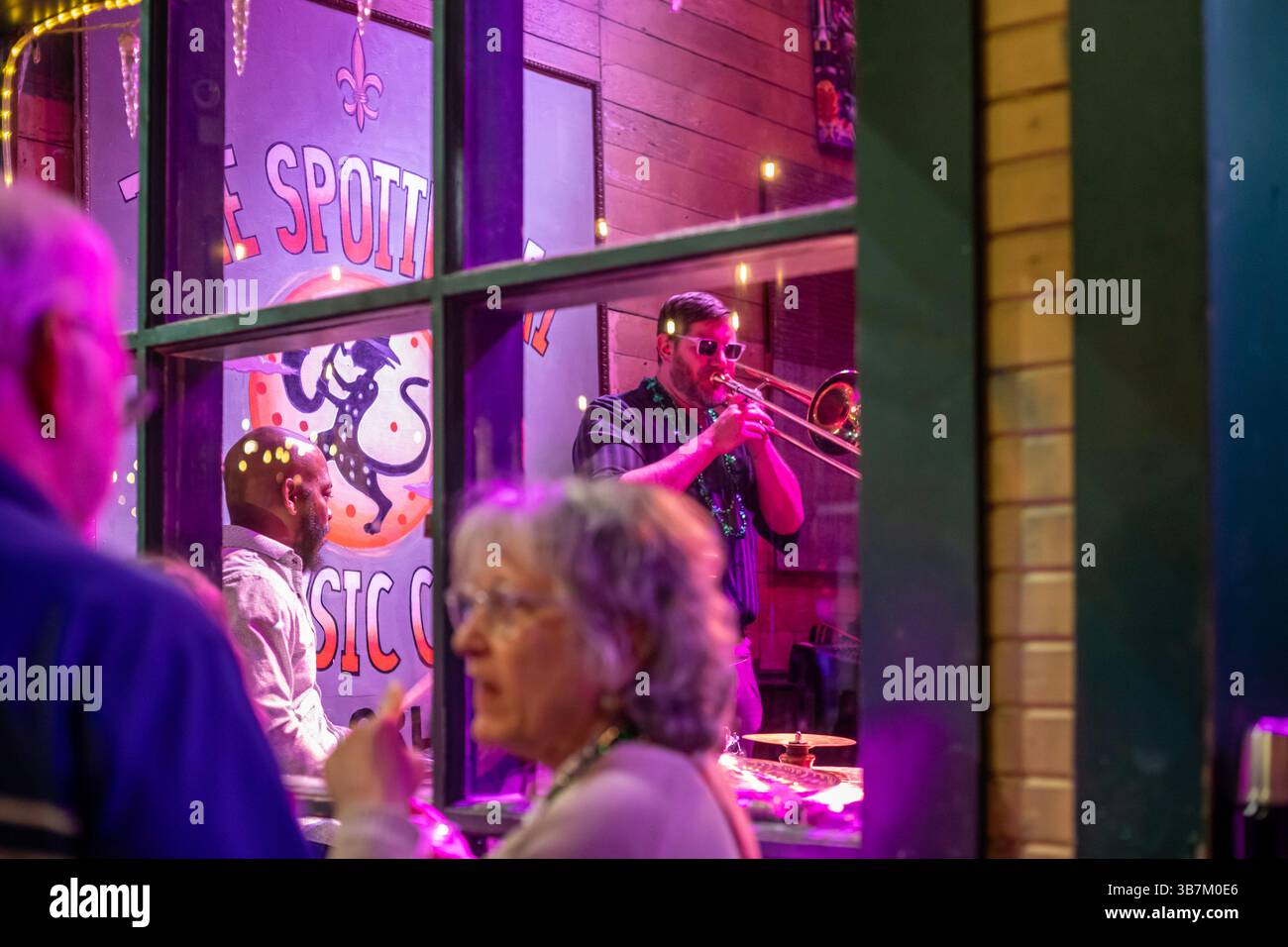 New Orleans, Louisiana - People watch outside as a band plays at The ...