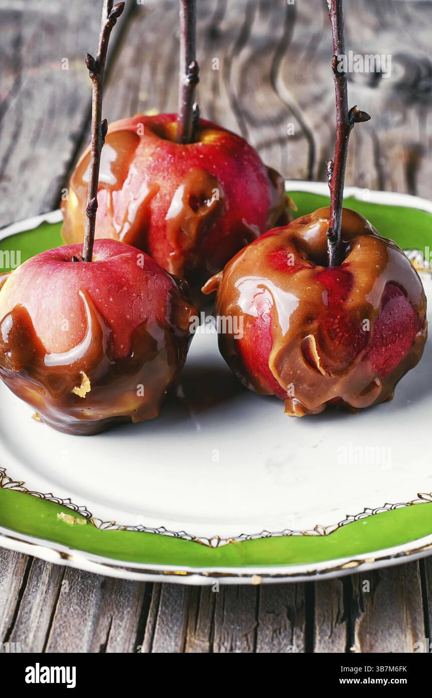 Apples with toffee caramel decorated with branch Stock Photo - Alamy
