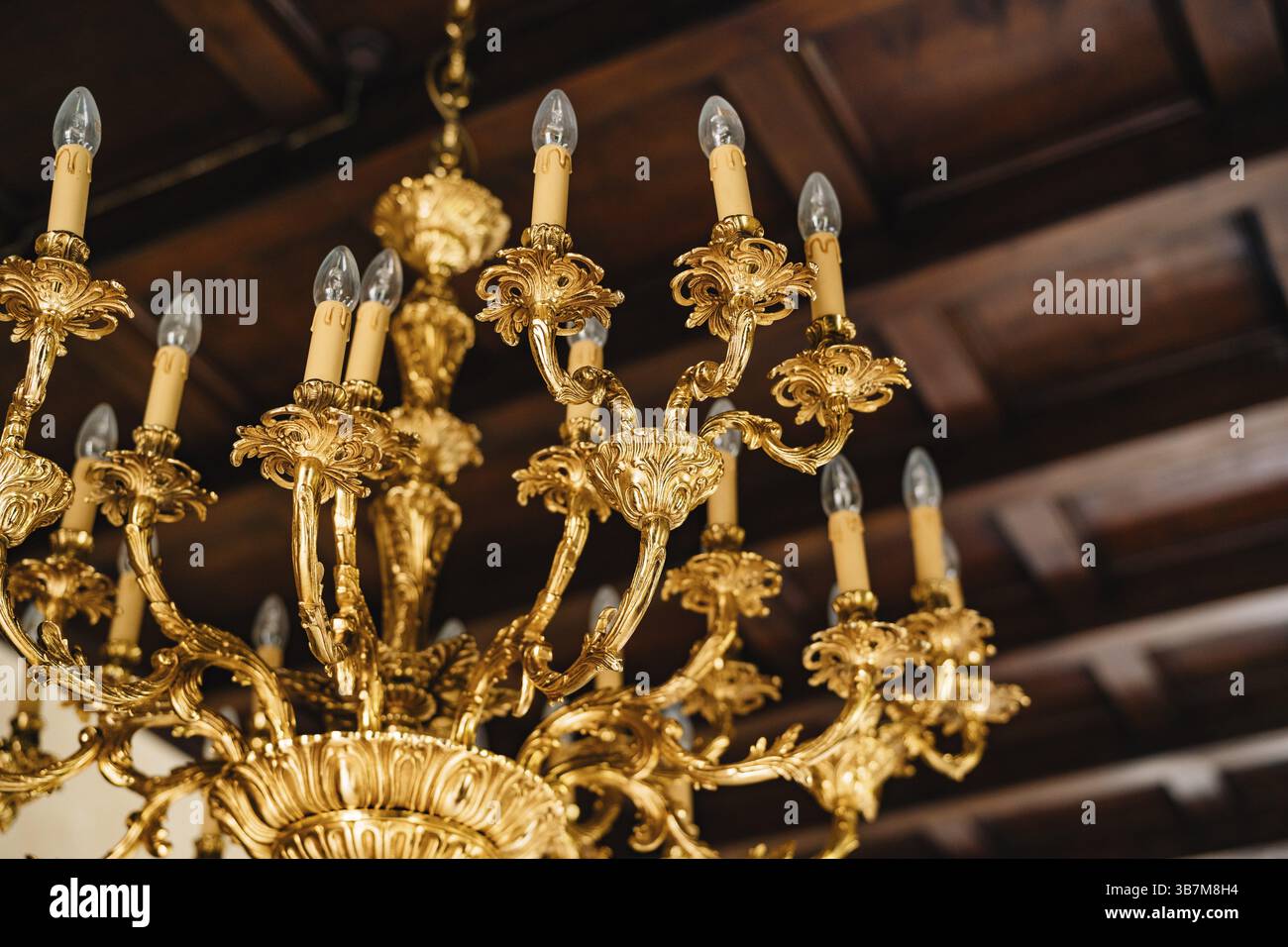 Electric chandelier with bulbs. Antique golden chandelier in the ...