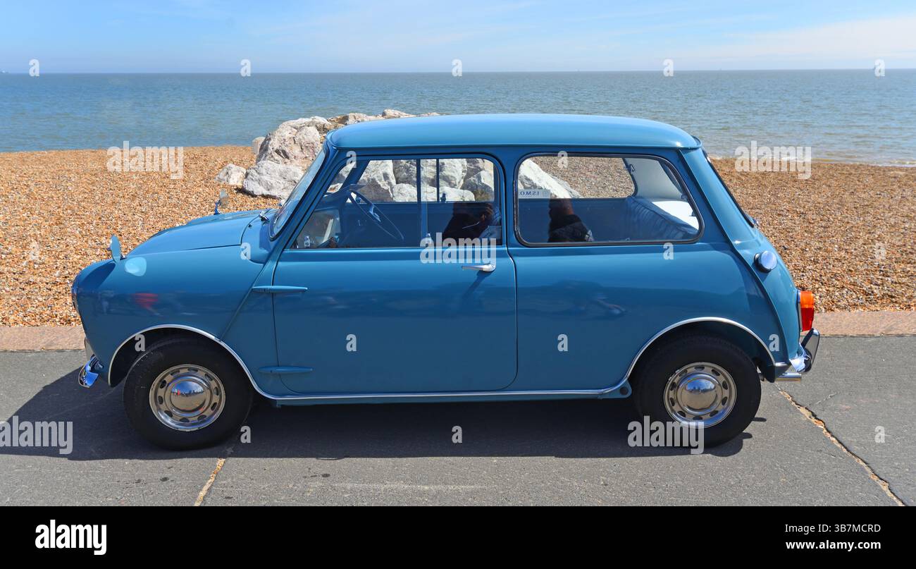 Classic blue Mini motor car parked on seafront beach and sea in ...