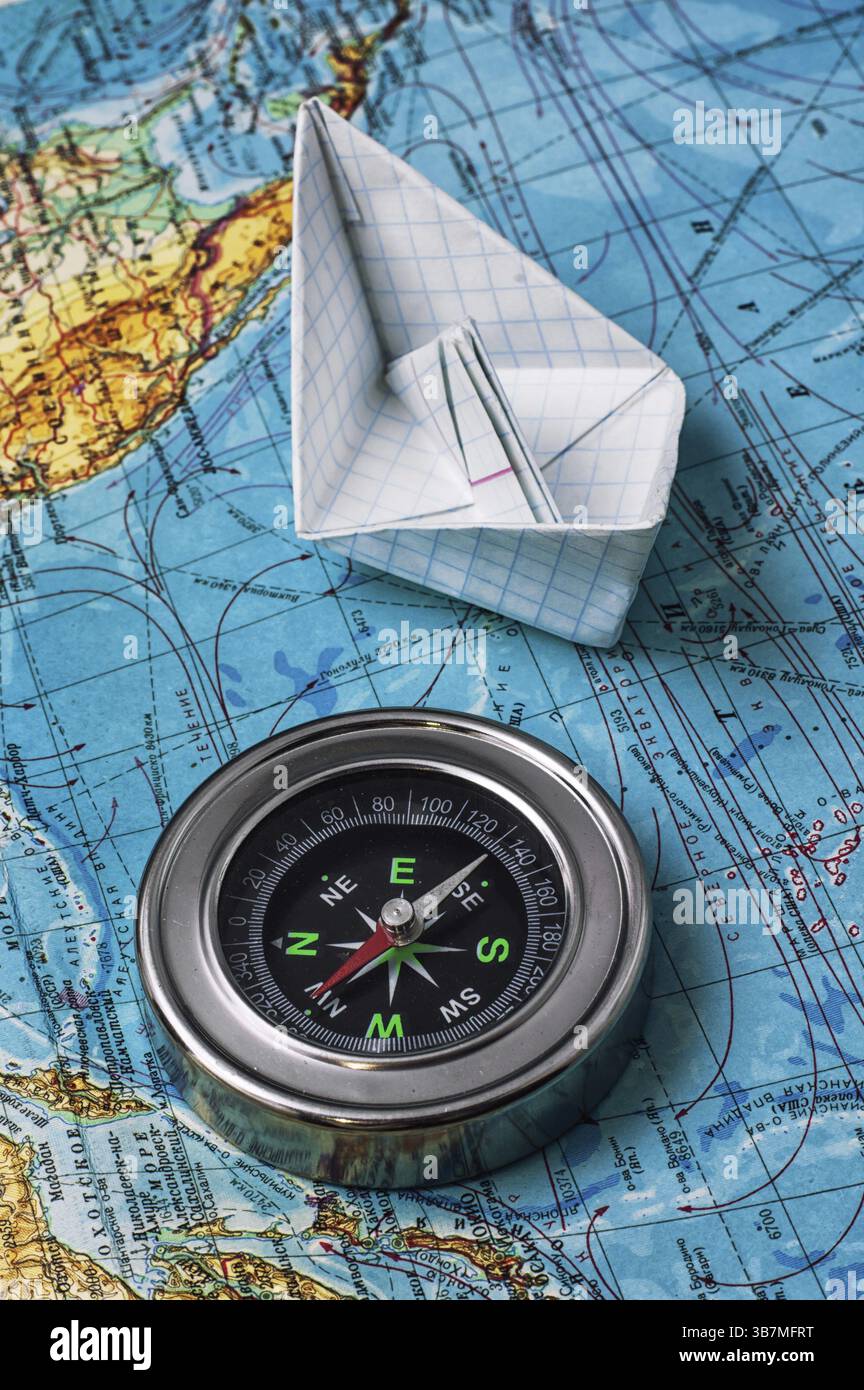 Outdated compass sailor on a topographic map Stock Photo - Alamy