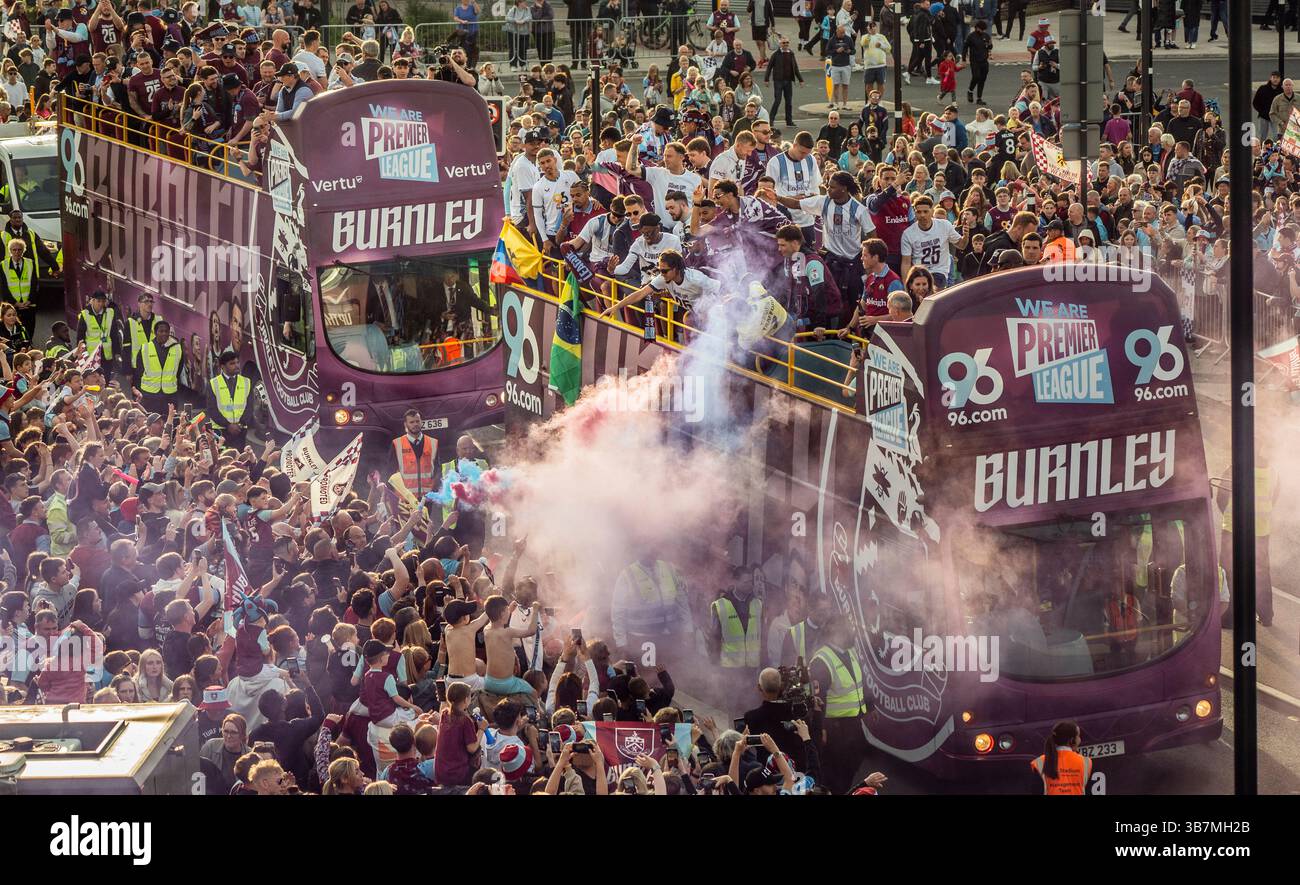 Fans line the street as the Burnley parade buses pass through the town ...