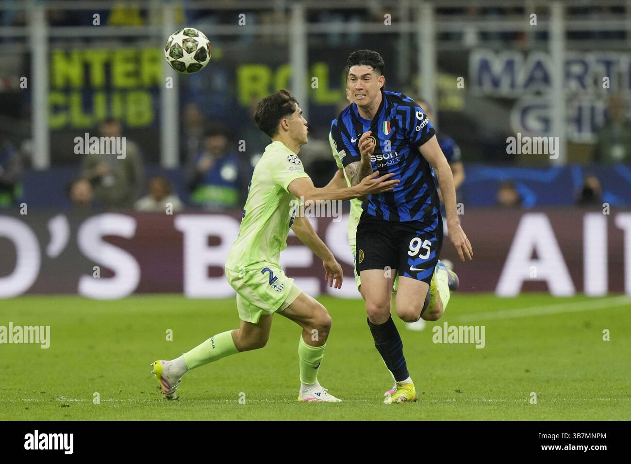 Inter Milan's Alessandro Bastoni, right, is challenged by Barcelona's ...