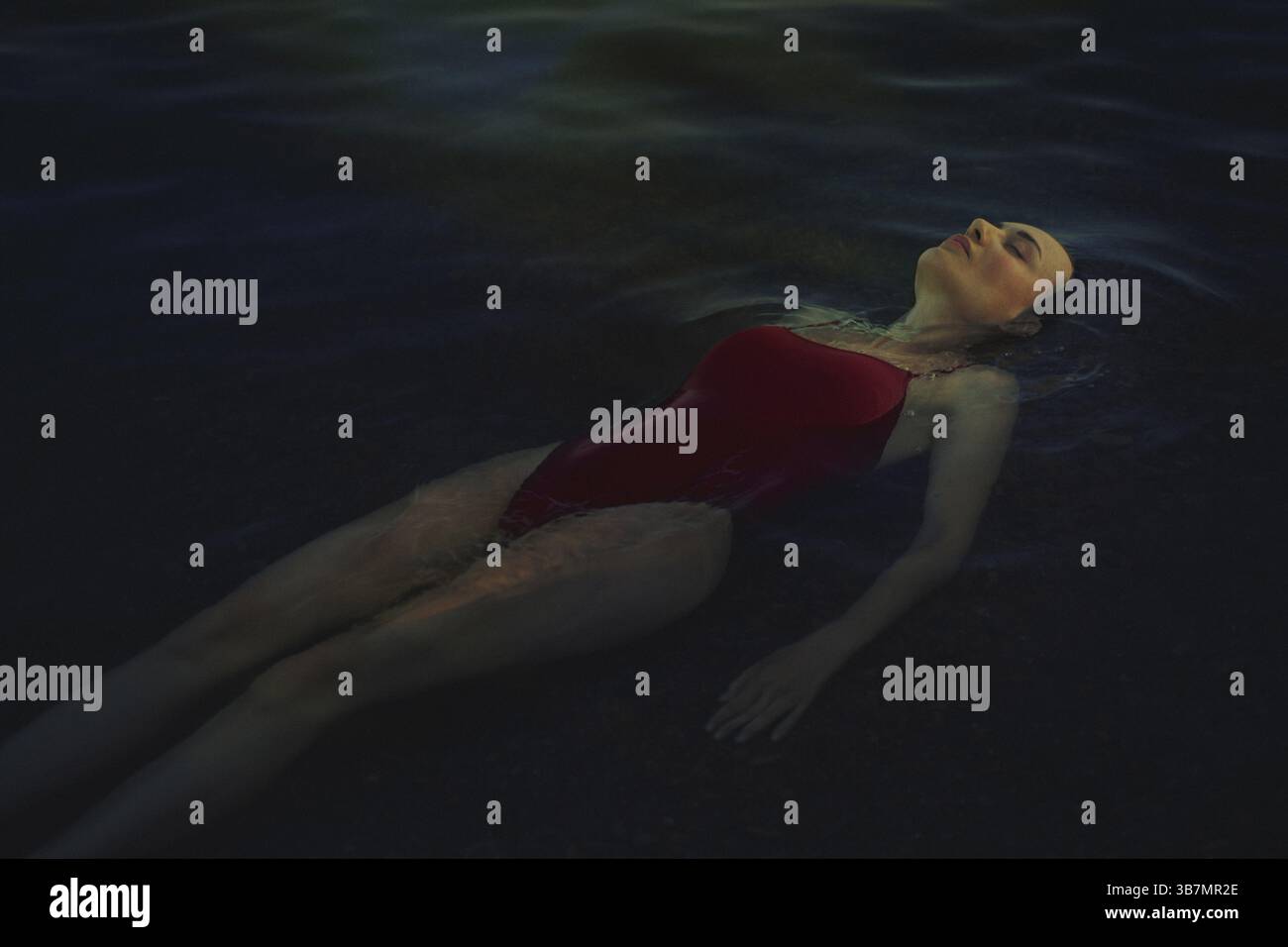 Serene blond woman lying down and relaxing in the rippled sea Stock ...