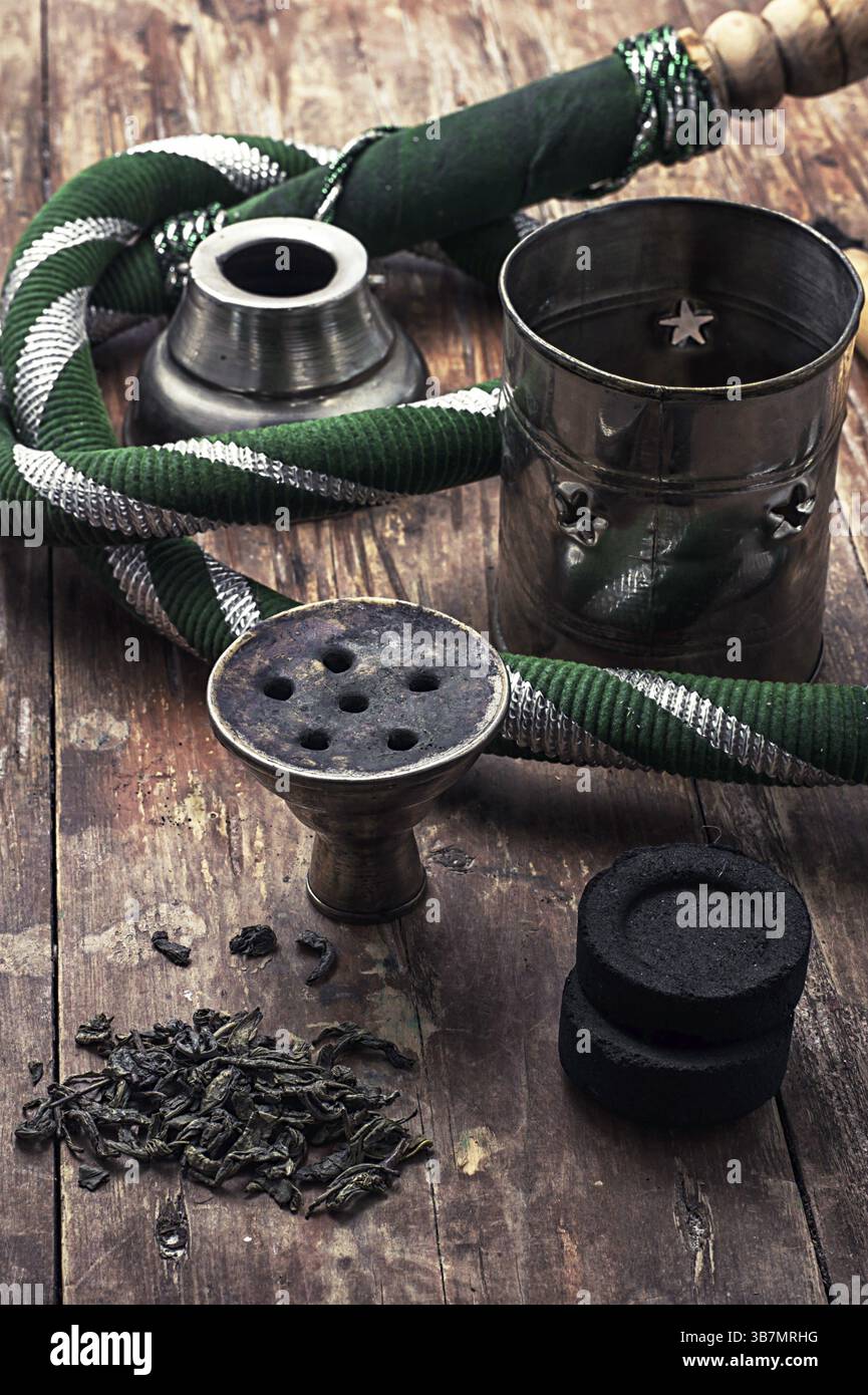 Details Shisha and accessories on wooden background.image is tinted in ...