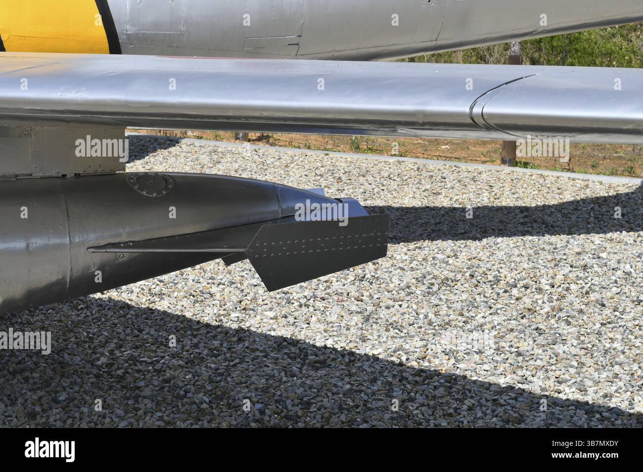 Rear section of external fuel tank mounted under wing of fighter jet on ...