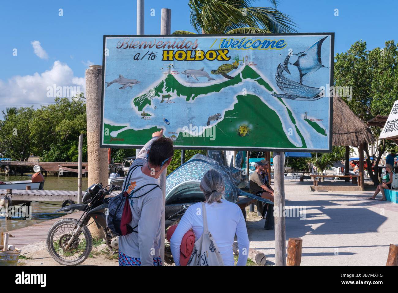 Holbox, Mexico - 9 February 2025: Two travelers examine a large ...