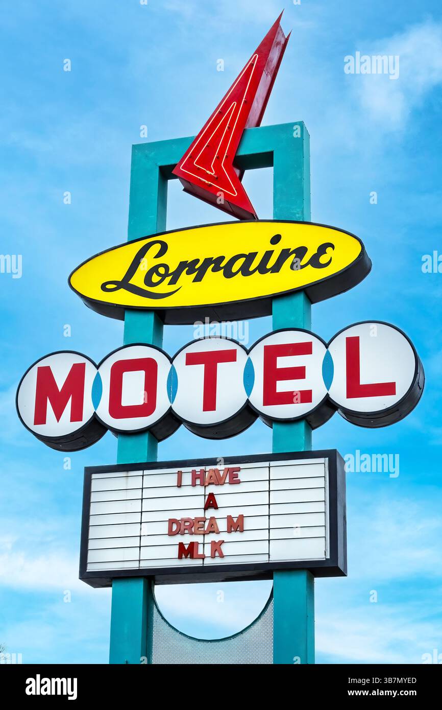 A vintage sign for Lorraine Motel stands against a clear blue sky ...