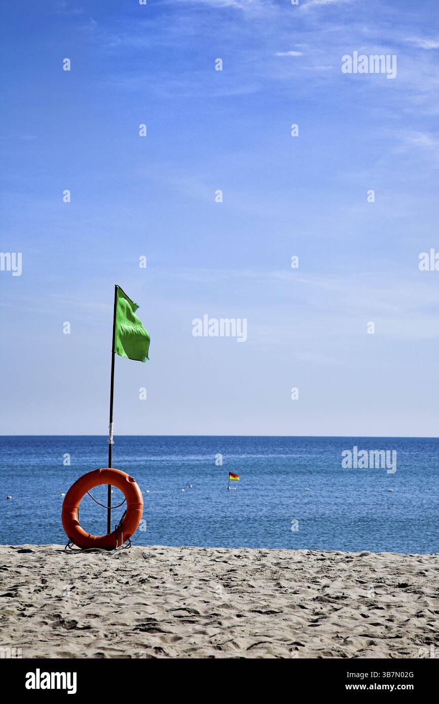 Beach green flag good weather wind Stock Photo - Alamy