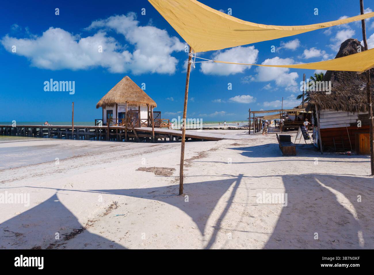 Holbox, Mexico - 9 February 2025: Long shadows from beach canopies fall ...