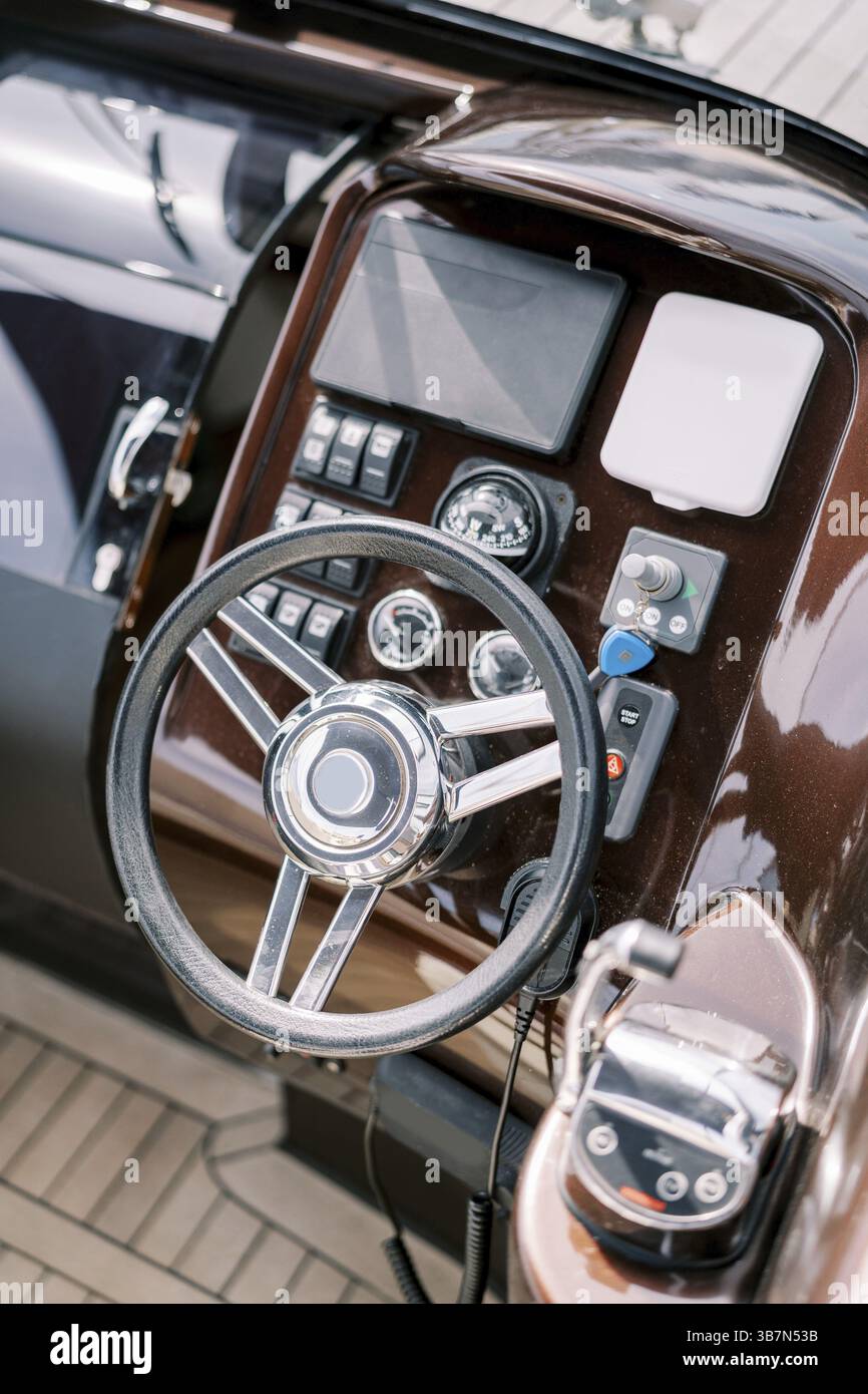 Steering wheel and control panel of a modern motor yacht. Top view ...