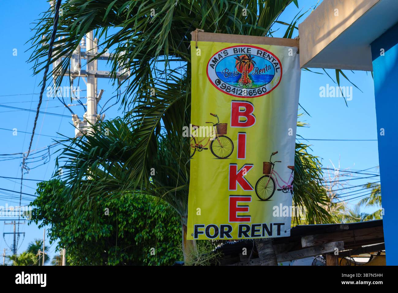 Isla Holbox, Mexico – 12 February 2025: Sign promoting local bike rental services scattered ...